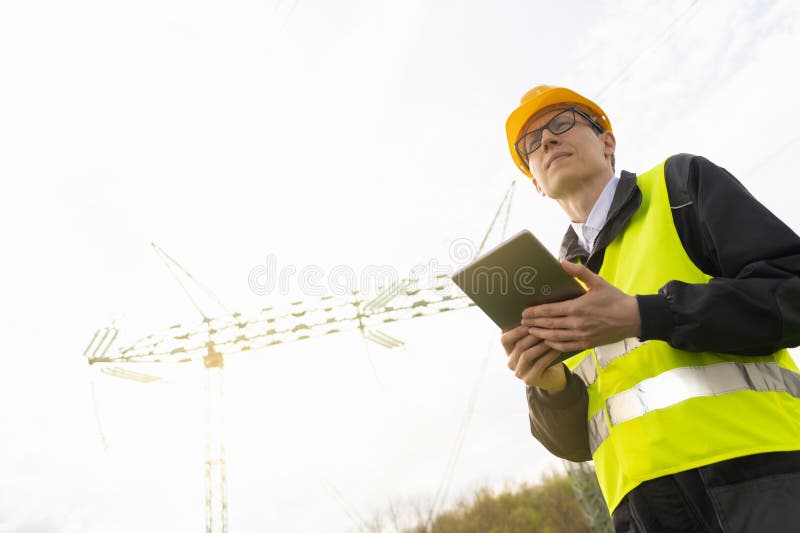Engineer with Digital Tablet on a Background of Power Line Tower Stock ...