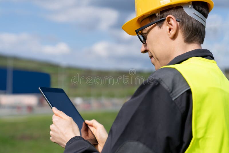 Engineer with Digital Tablet on a Background of Power Line Tower. Stock ...