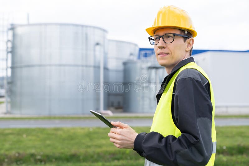 Engineer with Digital Tablet Works on a Field of Wind Turbines Stock ...