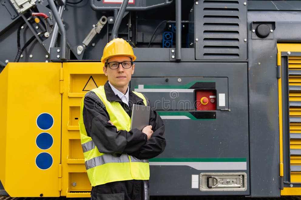 Engineer with Digital Tablet Next To Road Construction Machine Stock ...