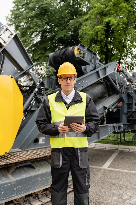 Engineer with Digital Tablet Next To Road Construction Machine Stock ...