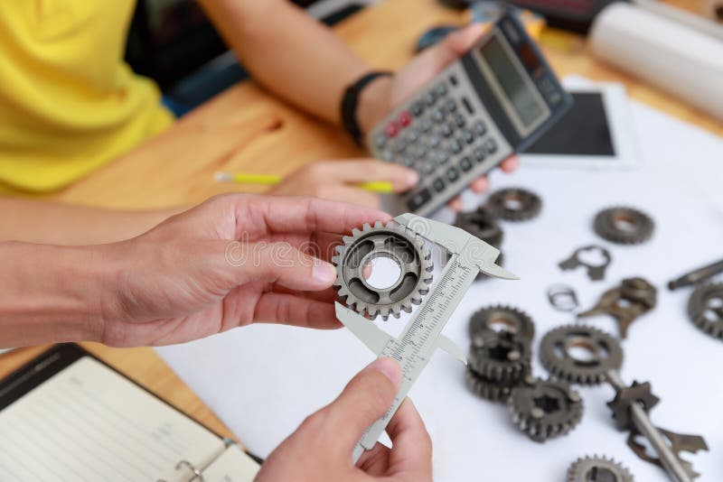Engineer Discussing and Designing about Mechanical Gear Parts in Office ...
