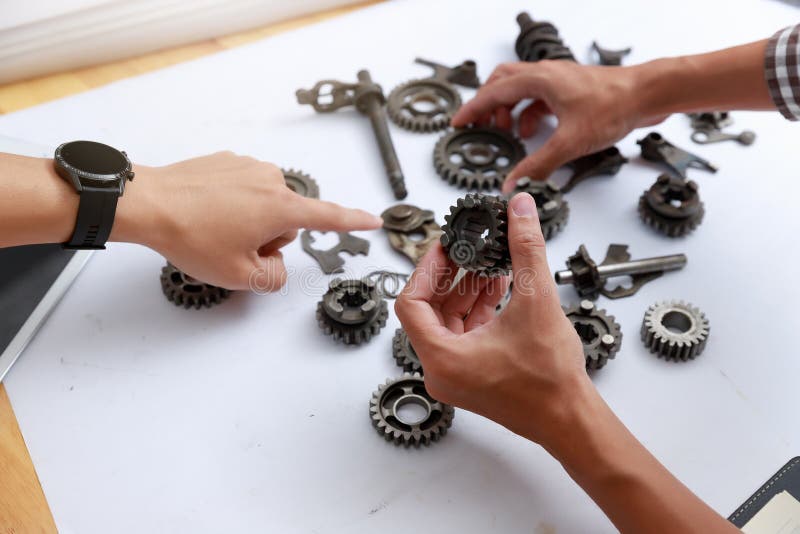 Engineer Discussing and Designing about Mechanical Gear Parts in Office ...