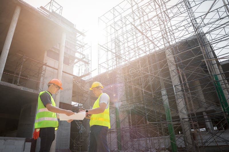 Engineer Discussing with Foreman about Project in Building Construction ...