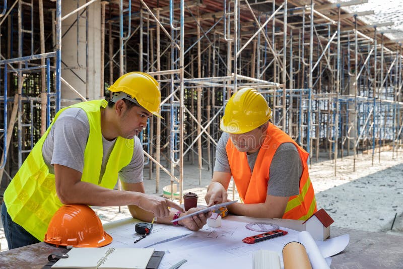 Engineer Discussing with Foreman about Project in Building Construction ...