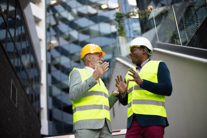 Engineer Discussing the Structure of the Building with Architects ...