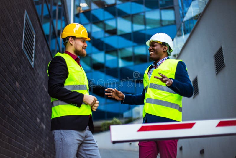 Engineer Discussing the Structure of the Building with Architects ...