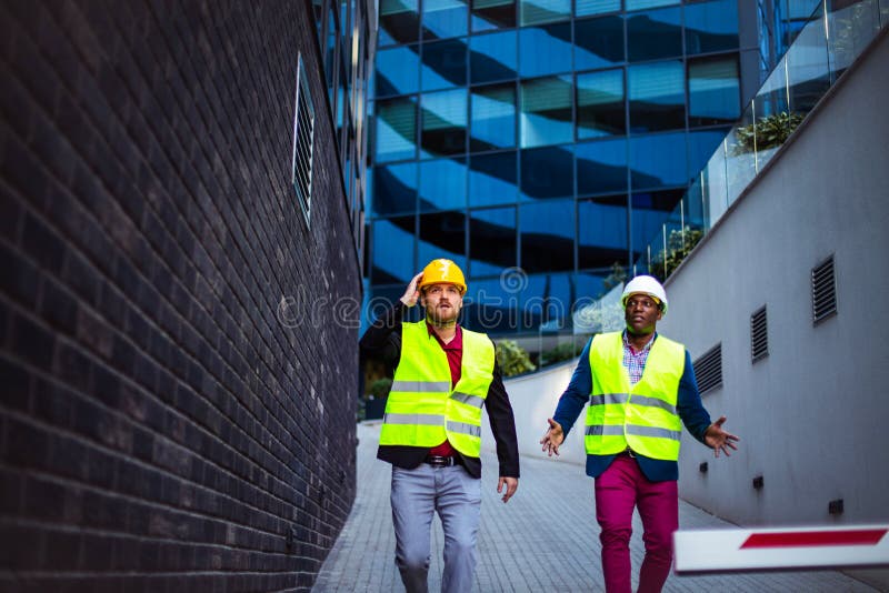 Engineer Discussing the Structure of the Building with Architects ...