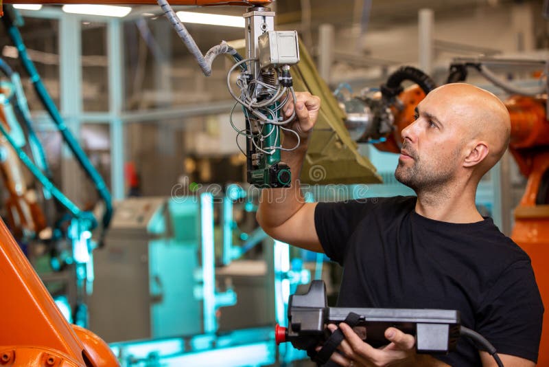 Engineer Doing Maintenance for Automatic Robot Arms in Smart Automotive ...