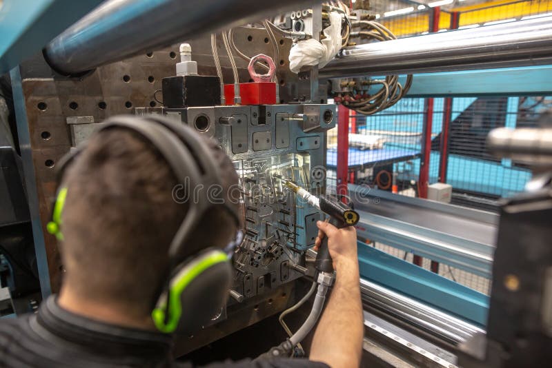 Engineer Doing Maintenance on a Injection Mold for Plastic Components ...