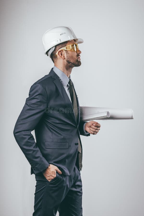 Engineer with Drafts Looking Away Stock Photo - Image of blueprints ...