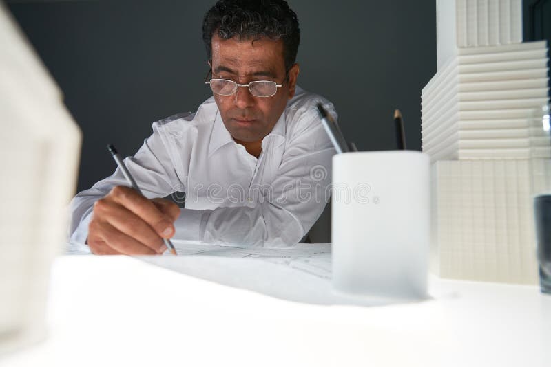 Engineer drawing sketch stock image. Image of serious - 77604621
