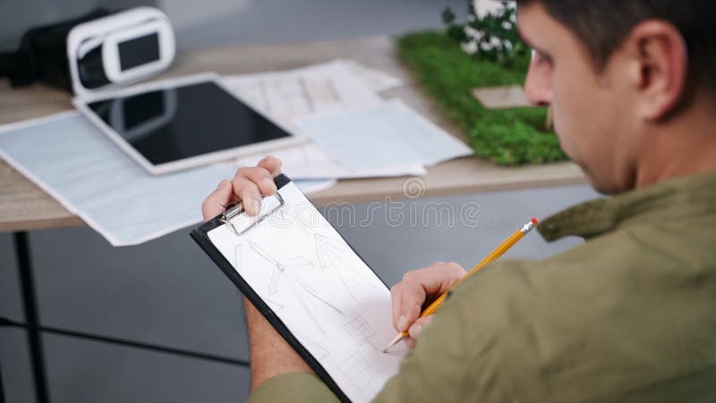 Engineer Drawing Wind Turbines while Working with Environmental Project ...