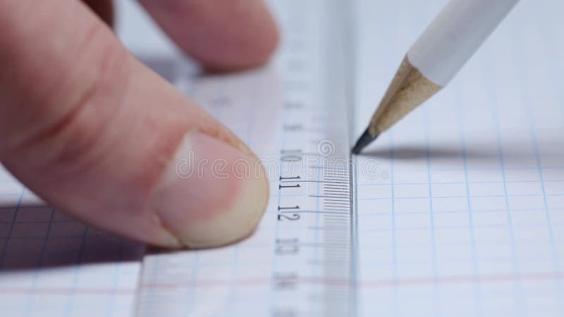 An Engineer Draws His Project in a Notebook Under a Ruler with a Pencil ...