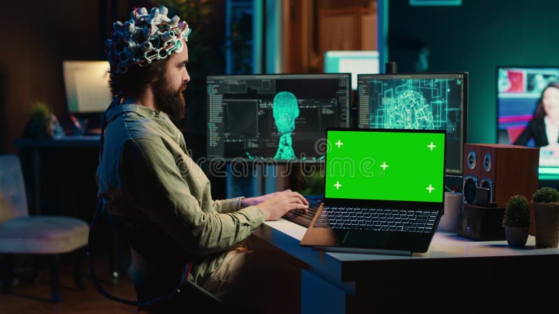 Engineer with EEG Headset on Merging with AI, Green Screen Laptop Stock ...