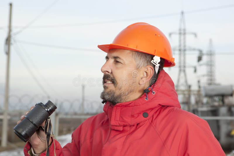 Engineer at Electrical Substation Looks through a Binoculars Stock ...