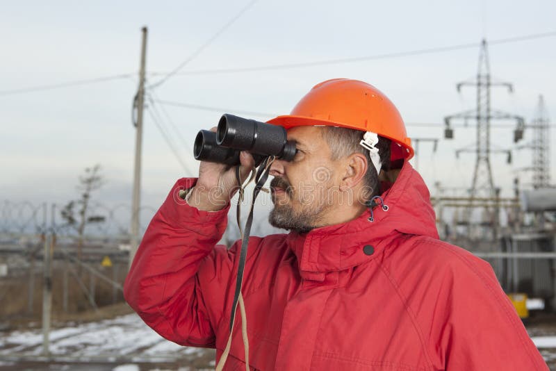 Engineer at Electrical Substation Looks through a Binoculars Stock ...