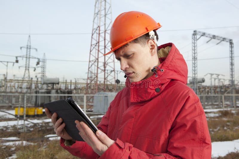 Engineer at Electrical Substation Using a Tablet Computer Stock Image ...