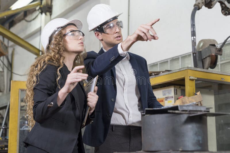 The Engineer is Explaining the Operation of the Machine To the Manager ...