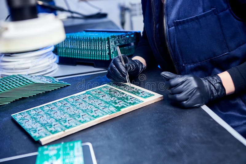 Engineer Factory Worker Electronics Works with a Chip Board. Microchip ...