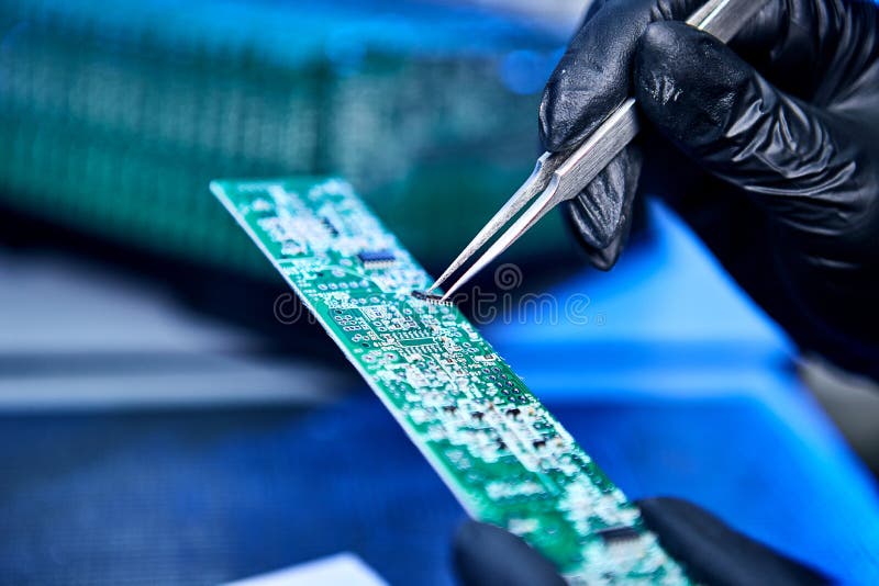 Engineer Factory Worker Electronics Works with a Chip Board. Microchip ...