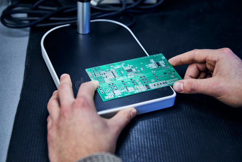 Engineer Factory Worker Electronics Works with a Chip Board. Microchip ...