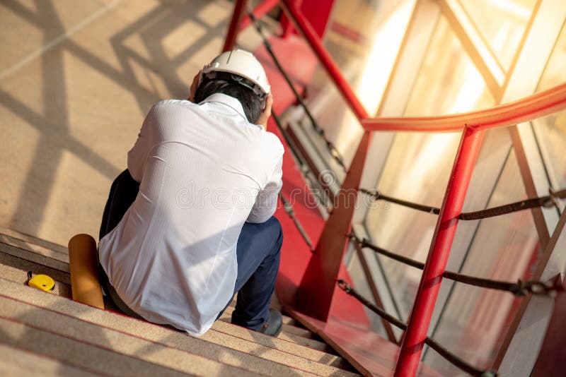 Engineer Feeling Stressed and Tired while Sitting at Construction Site ...