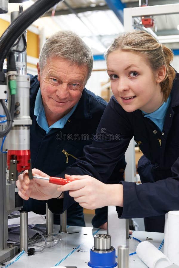 Female Apprentice Engineer Working on Machine in Factory Stock Image ...