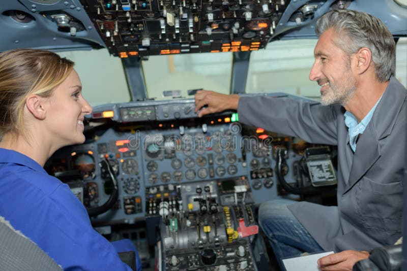 Engineer and Female Student in Cockpit Stock Photo - Image of seat ...