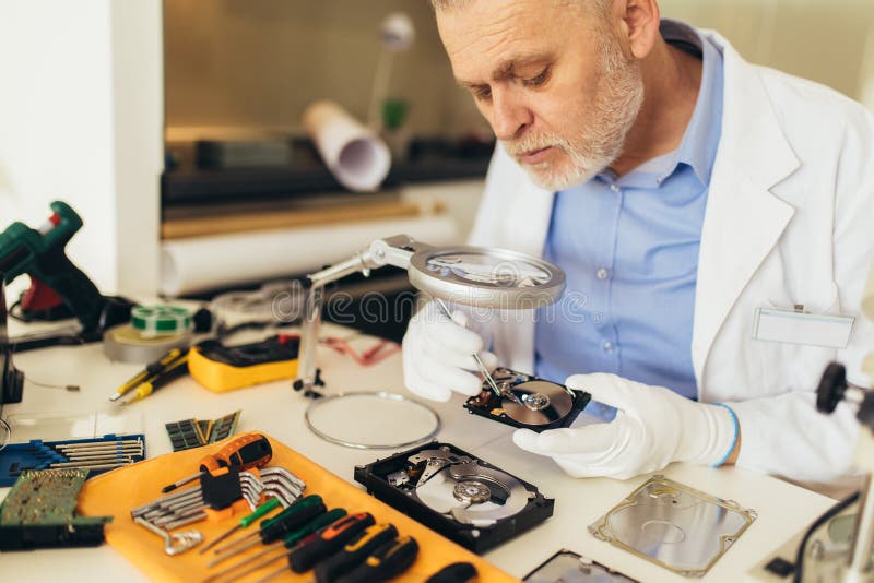 Engineer Fixing Broken Computer Hard Disc. Stock Image - Image of ...