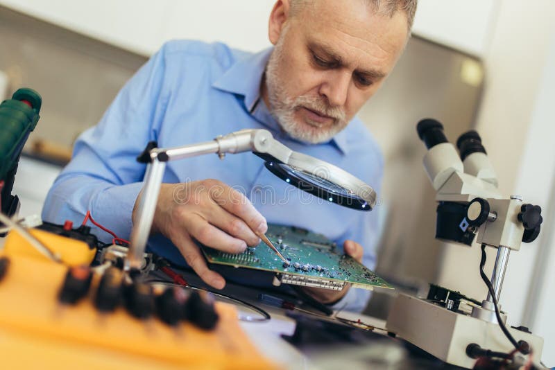 Engineer Fixing Broken Computer Motherboard. Stock Photo - Image of ...