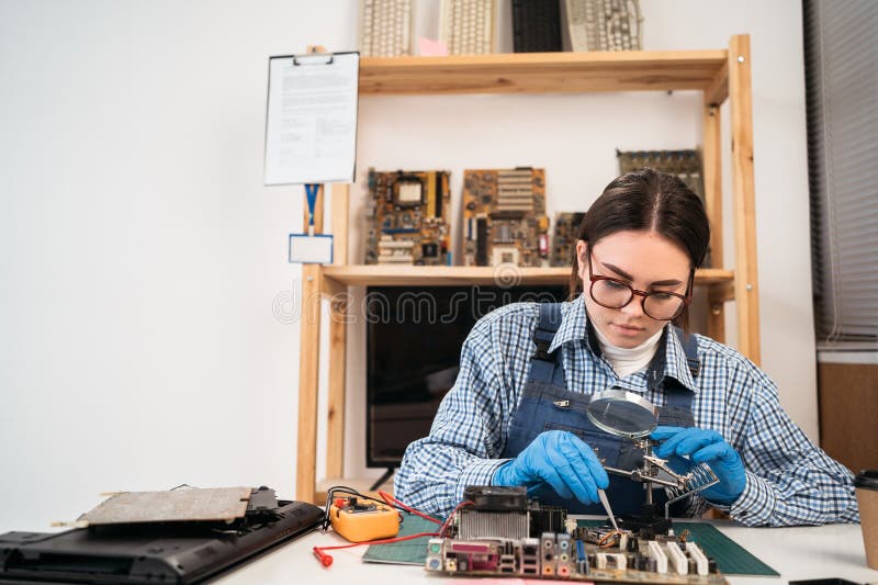 Engineer Fixing Broken Computer Motherboard Using Tweezers. Electronic ...