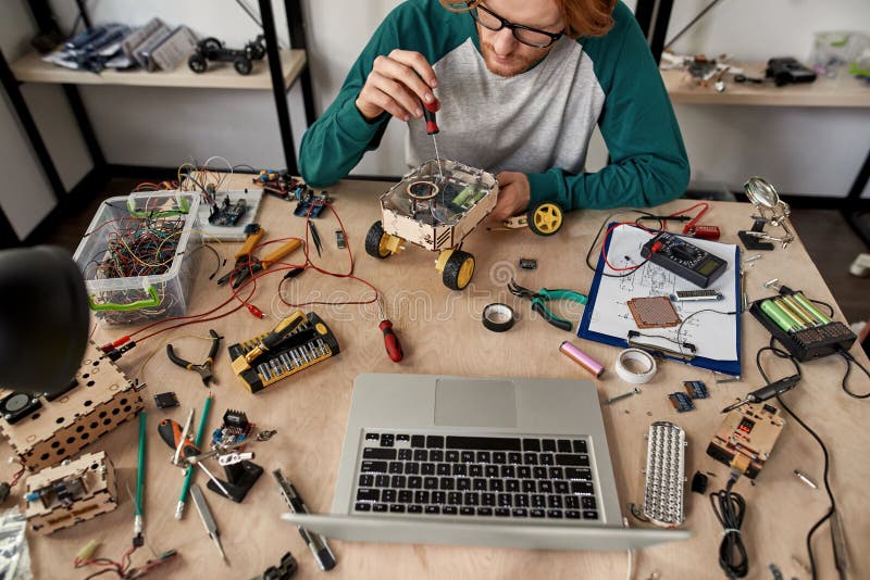It Engineer Fixing Broken Robot with Screwdriver Stock Photo - Image of ...