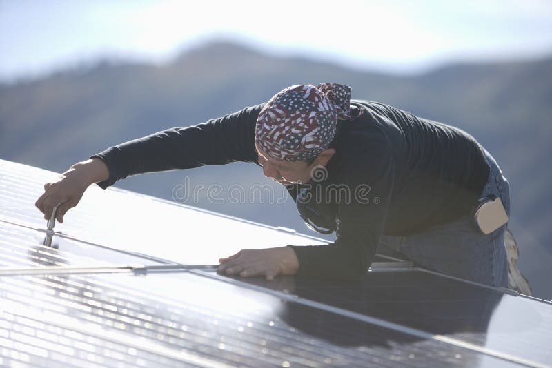 Man Fixing Solar Panel on Rooftop Stock Photo - Image of palm ...