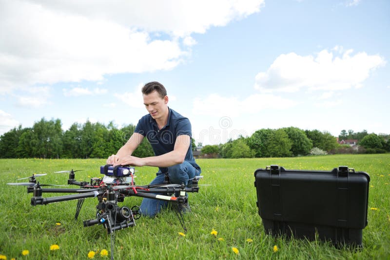 Technician Flying UAV Octocopter in Park Stock Photo - Image of ...