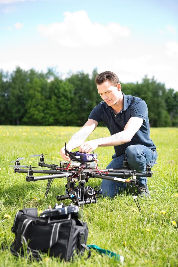 Engineer Fixing UAV Helicopter in Park Stock Photo - Image of multi ...