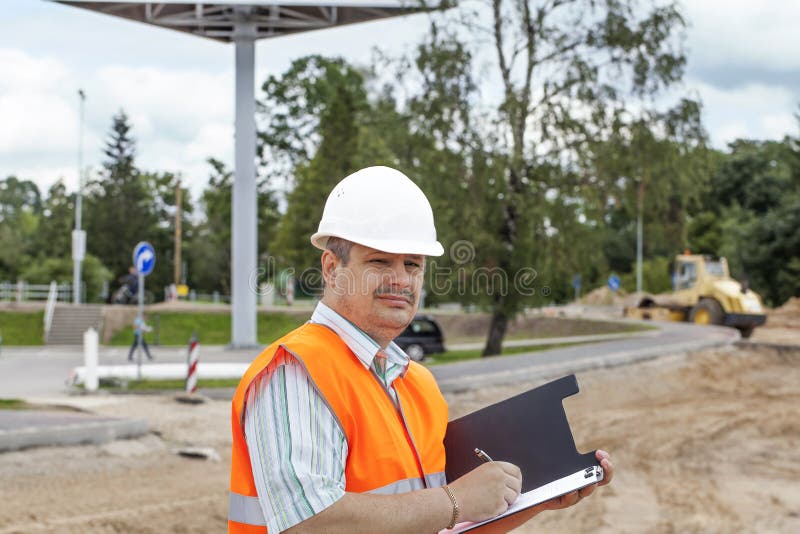 Engineer with Folder Near the Road Repair Stock Photo - Image of ...