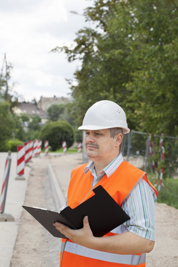 Engineer with a Folder Near the Sidewalk Stock Image - Image of ...