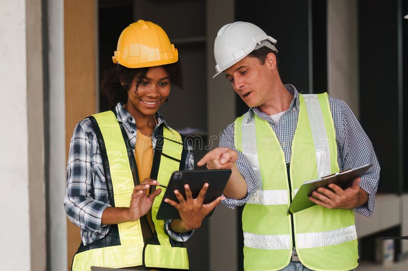 Engineer and Foreman Builder Team at Construction Site. American ...