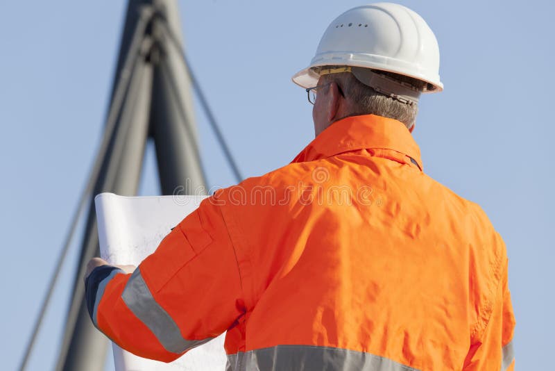 Engineer or Foreman with Hard Hat and Protective Workwear Reading a ...