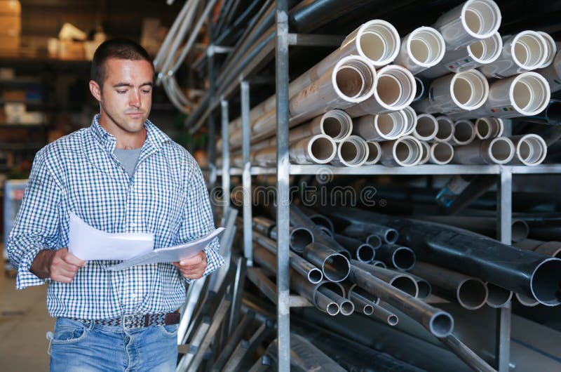 Engineer or Foreman Holding Documents and Checking Inventory or Job ...