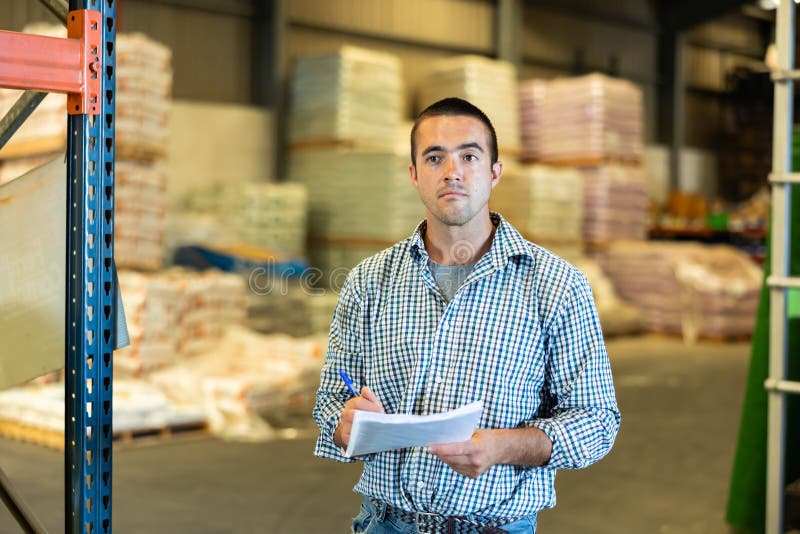 Engineer or Foreman Holding Documents and Checking Inventory or Job ...