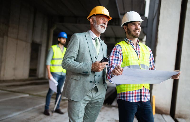 Engineer, Foreman and Worker Discussing in Building Construction Site ...
