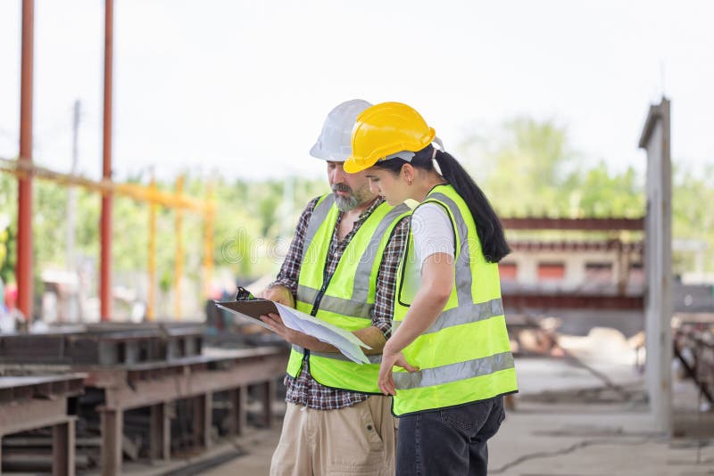 Engineer and Foreman Worker Team with Blueprints Checking Project at ...
