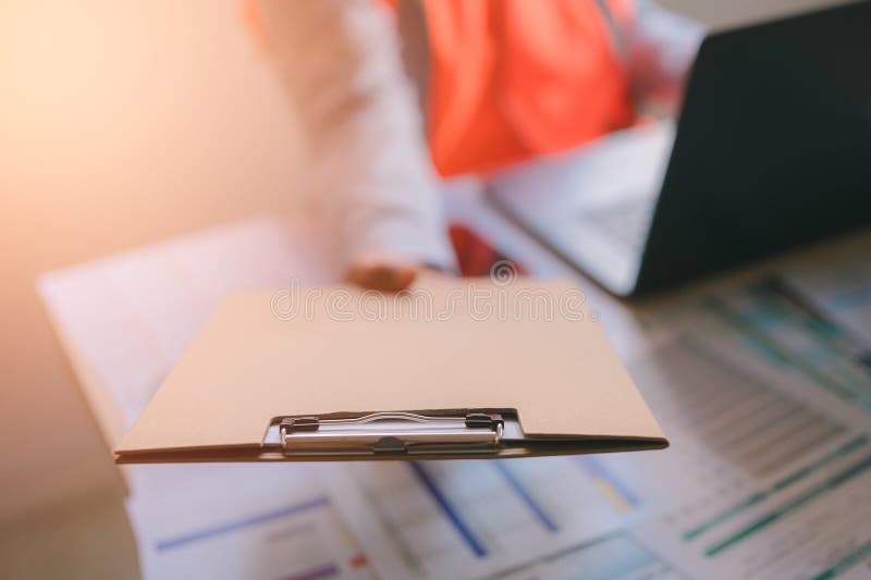 An Engineer or Foreman Working on Site Hand Holding or Handing Over ...