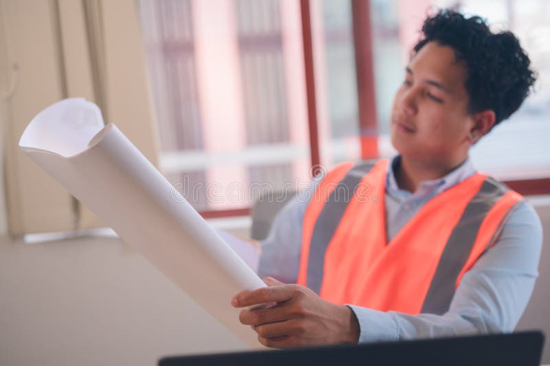 An Engineer or Foreman Working on Site Looking at Paper Plan or ...