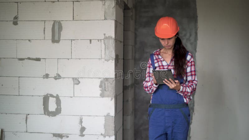 Engineer with Gadget in Building Under Construction. Modern ...