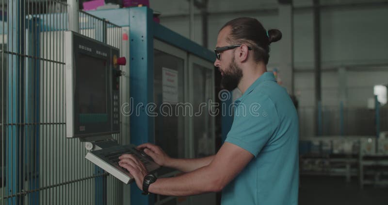 The Engineer in Glasses Works with Computer To Control the Process ...