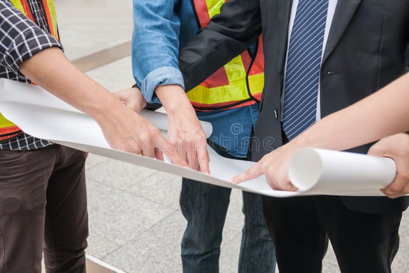 Engineer Group Pointing To Paper Sheet with Businessman Stock Image ...