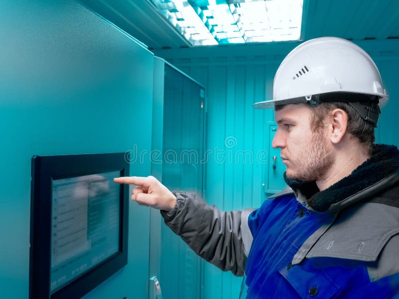 Engineer in Hard Hat Presses His Finger into Touch Screen of Modern ...